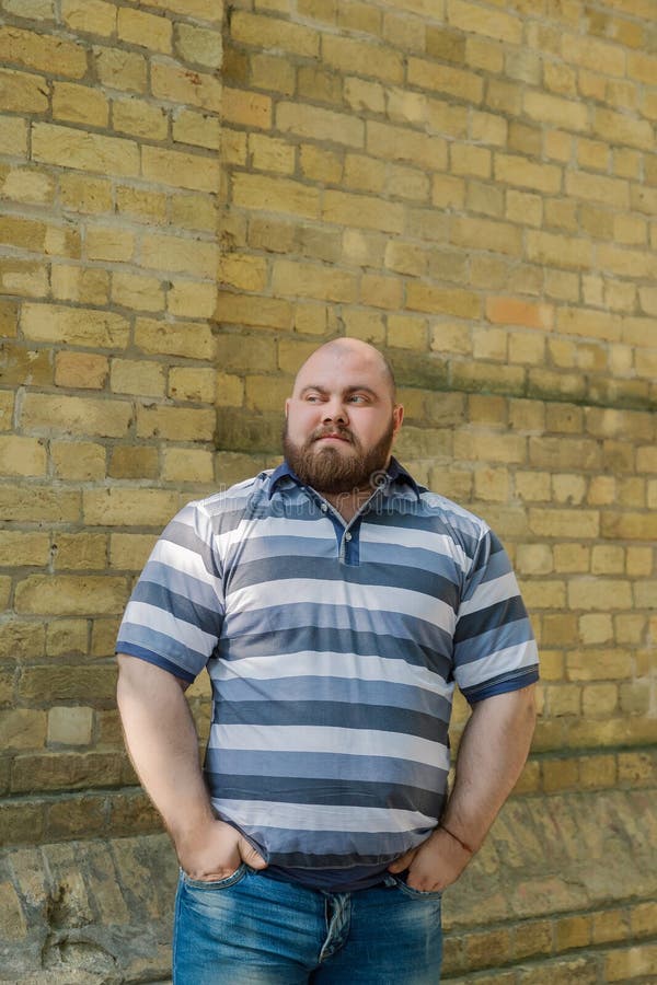Fat Man in the Park Looks into the Frame, a Portrait of a Man with ...