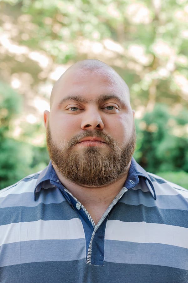 Fat Man in the Park Looks into the Frame, a Portrait of a Man with ...