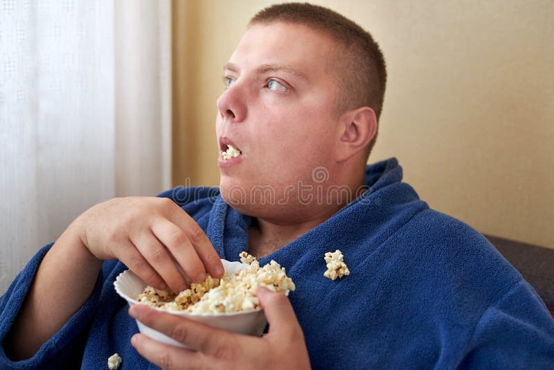 Fat Man in a Robe Eating Popcorn while Sitting on the Couch Stock Image ...