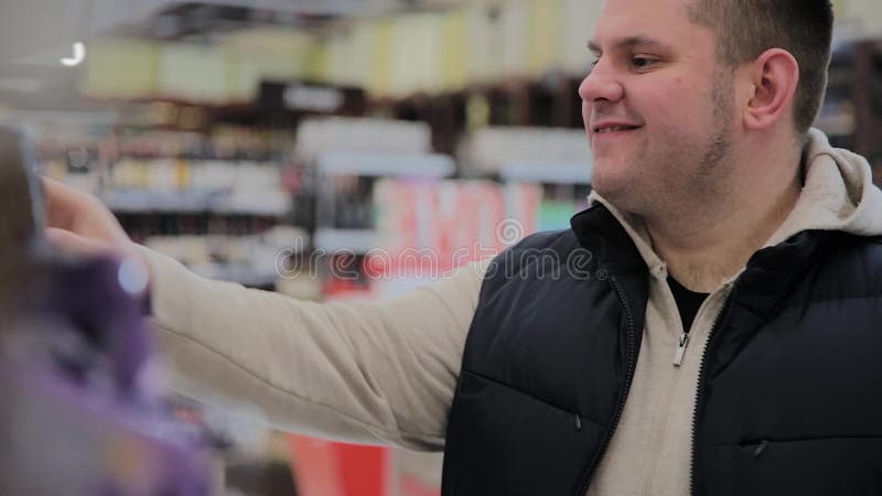 Fat Man in the Supermarket Chooses Food for Himself. Stock Video ...