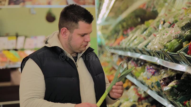 Fat Man in the Supermarket Chooses Fruit for Himself. Stock Footage ...