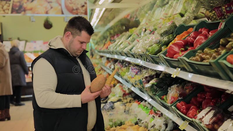 Fat Man in the Supermarket Chooses Fruit for Himself. Stock Footage ...