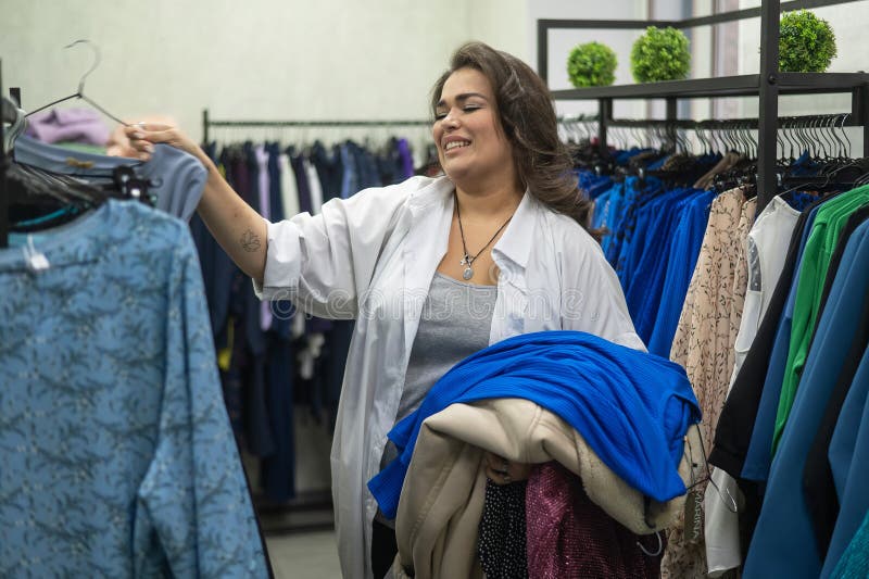 A Fat Woman Chooses Clothes in a Plus Size Store. Stock Image - Image ...