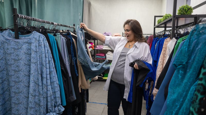A Fat Woman Chooses Clothes in a Plus Size Store. Stock Photo - Image ...