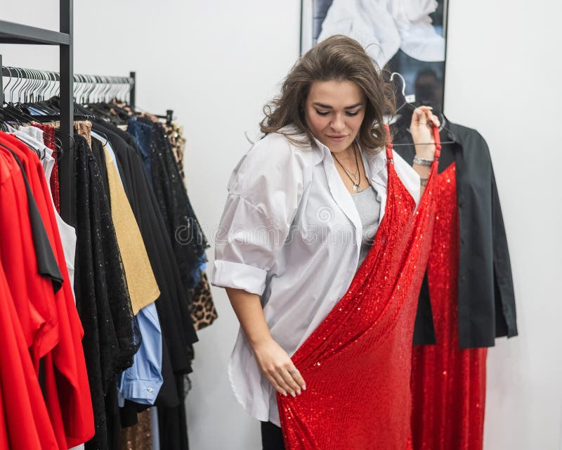 A Fat Woman Chooses Clothes in a Plus Size Store. Stock Image - Image ...
