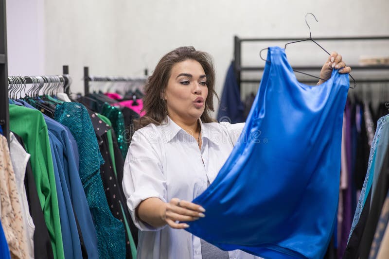 A Fat Woman Chooses Clothes in a Plus Size Store. Stock Image - Image ...
