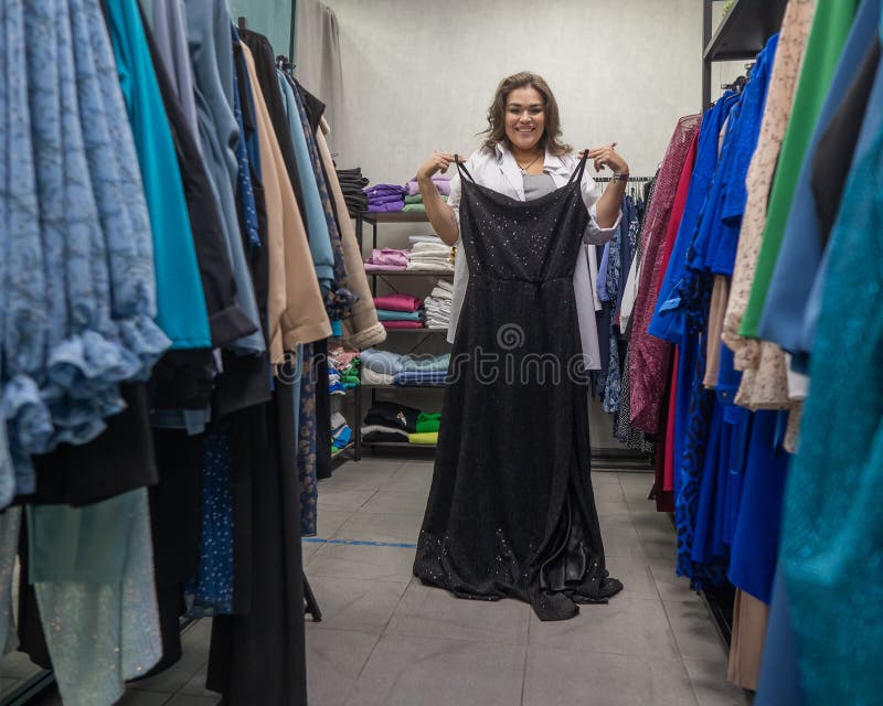 A Fat Woman Chooses Clothes in a Plus Size Store. Stock Photo - Image ...