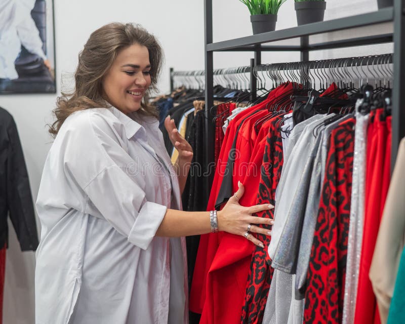 A Fat Woman Chooses Clothes in a Plus Size Store. Stock Image - Image ...