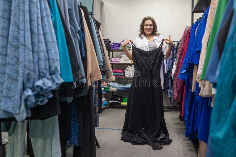 A Fat Woman Chooses Clothes in a Plus Size Store. Stock Photo - Image ...