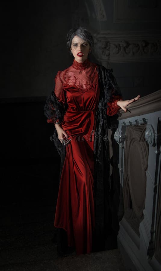 The Fatal Woman in a Black Dress with a Spray for Washing Glasses ...