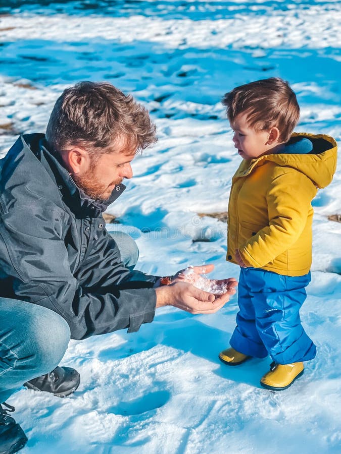 Father and Son Playing in the Snow Stock Photo - Image of playing ...