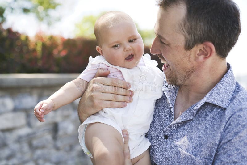 Father with Baby Girl Standing Outdoors by Tree. Stock Photo - Image of ...