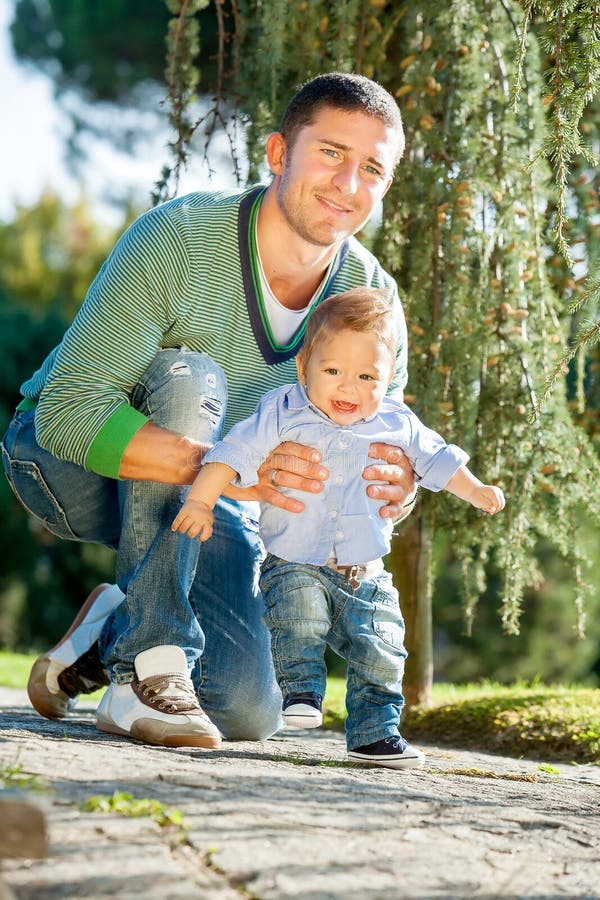 Father and Baby Play on the Grass Stock Photo - Image of garden, look ...