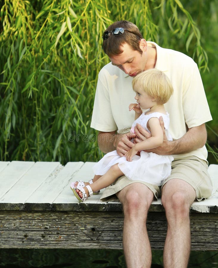 Father with a Baby Sitting on a Wooden Bench Stock Image - Image of ...