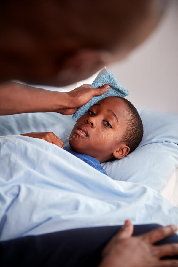 Father Caring for Sick Son Ill in Bed with Temperature Stock Image ...