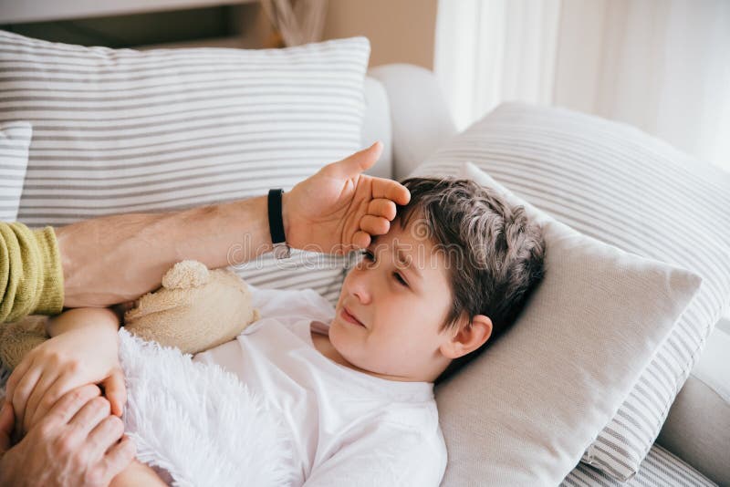 Father Caring for Sick Son Lying. Stock Photo - Image of illness ...