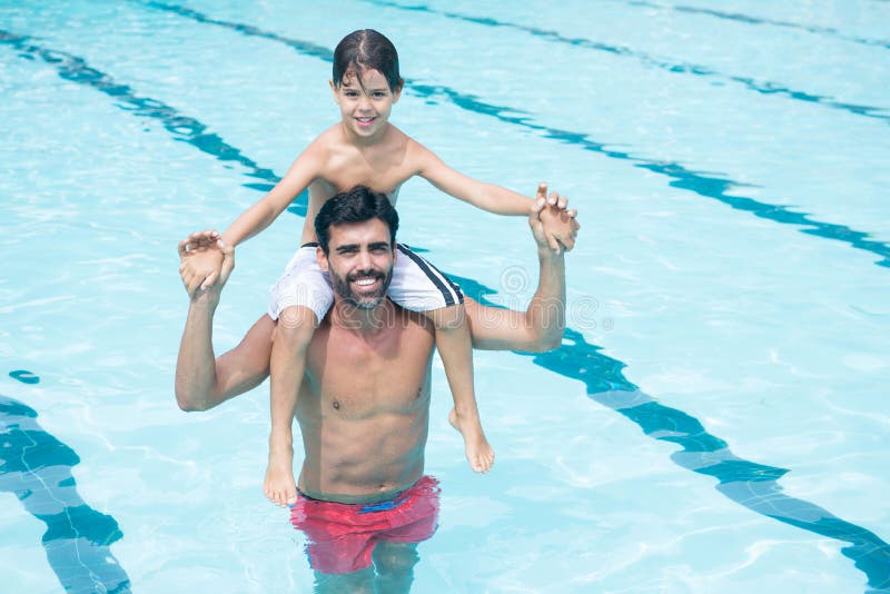 Father Carrying Son on Shoulder in Pool Stock Photo - Image of ...