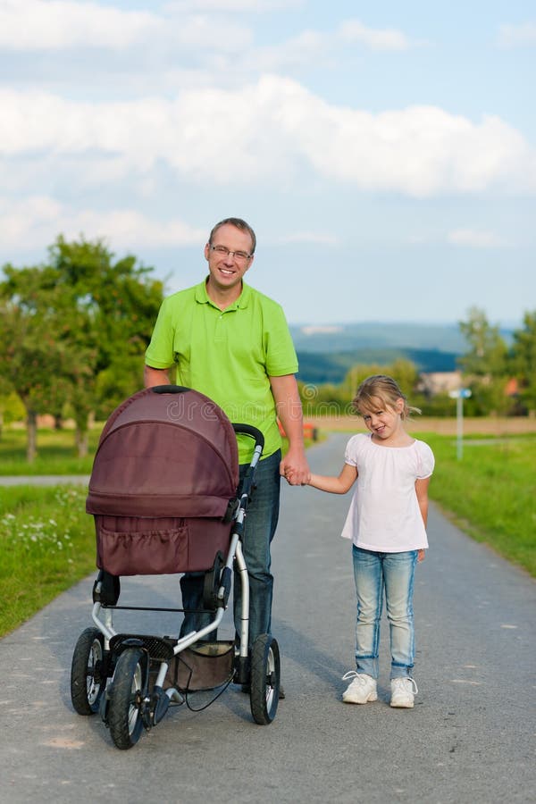 Father with Child and Baby Buggy Stock Photo - Image of baby, path ...