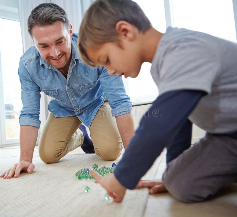 Father, Child and Playing Marbles Game on Floor for Development ...
