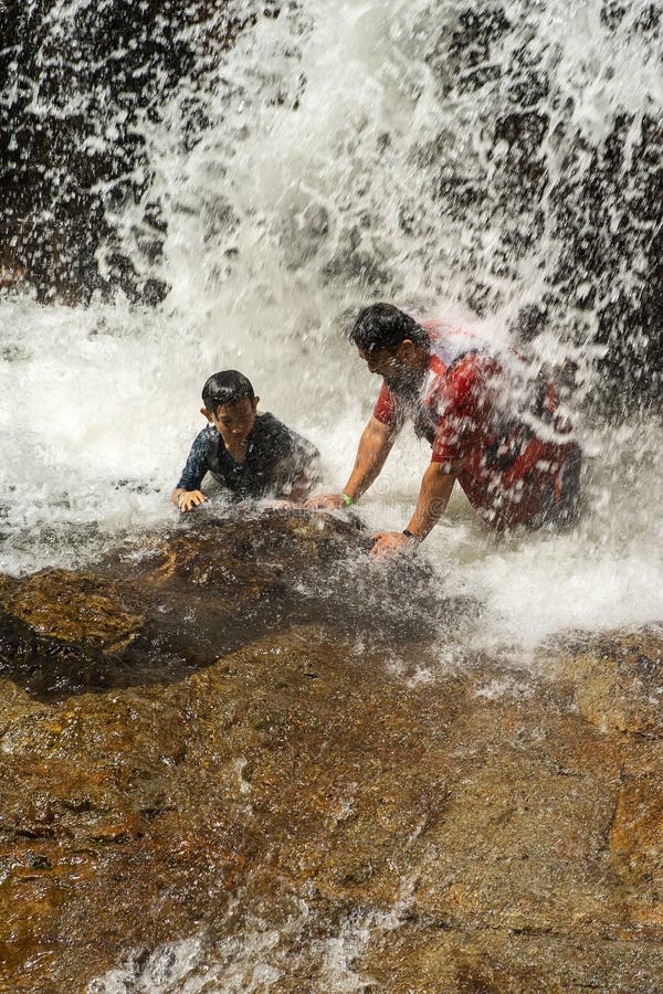 Father and Child Standing Under the Waterfall Stock Photo - Image of ...