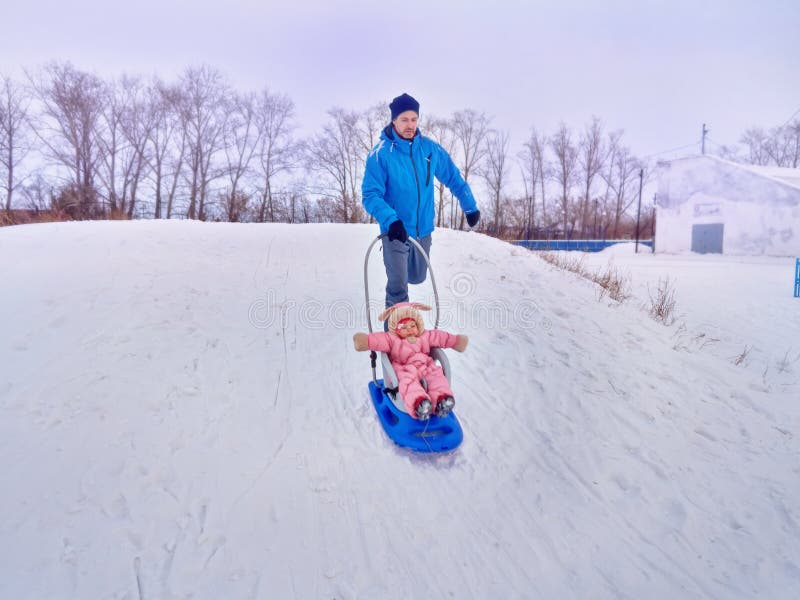 Father with Child Walk in the Winter the Sledge on Snow. Stock Photo ...