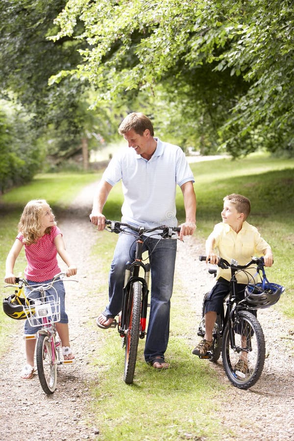 Father and Children Riding Bikes in Countryside Stock Image - Image of ...