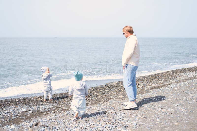 Father and Children Two Boys Twins Playing Having Fun on Beach in ...