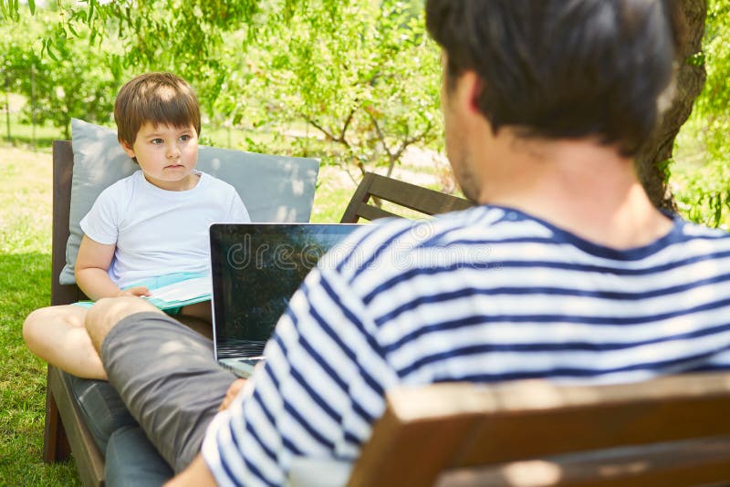 Father at the Computer in the Garden Together with Son Stock Photo ...