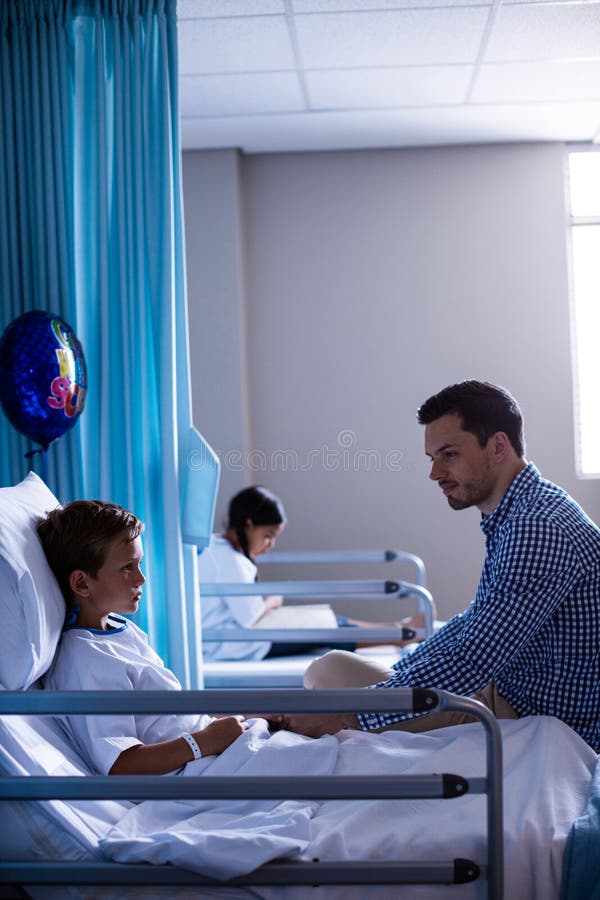 Father Consoling His Son during Visit in Ward Stock Photo - Image of ...