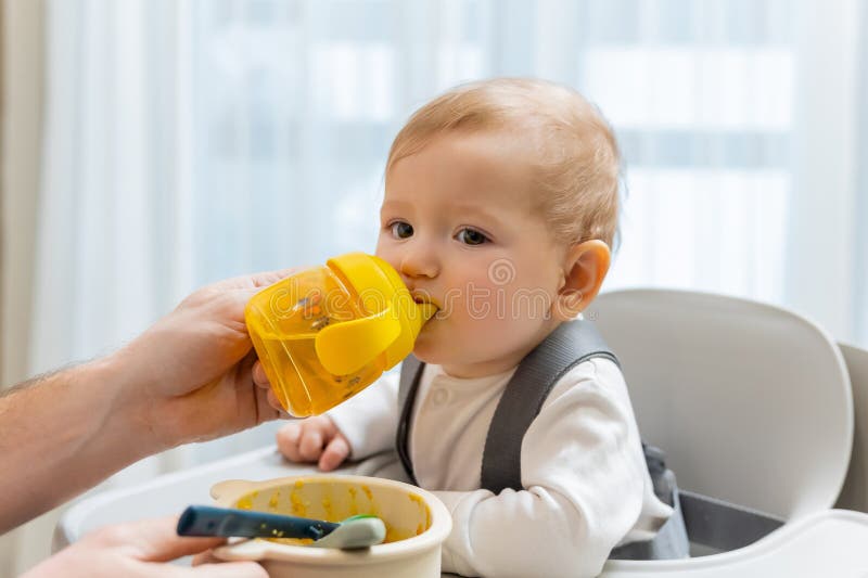 Father and a Cute Little Baby Boy Having Breakfast in the Kitchen Stock ...