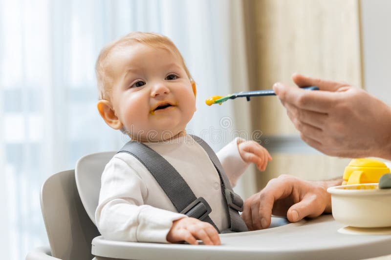 Father and a Cute Little Baby Boy Having Breakfast in the Kitchen Stock ...