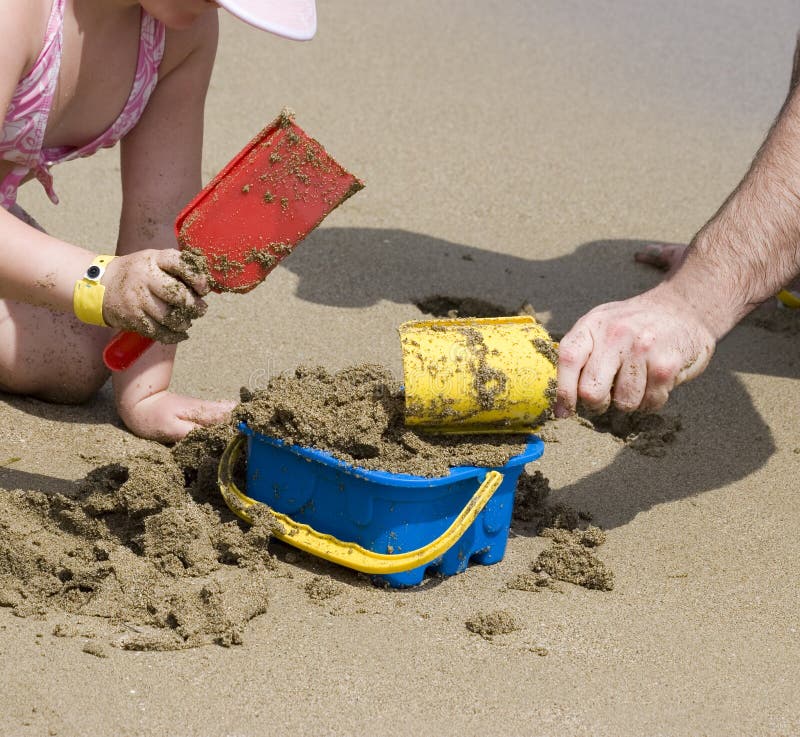 Father and Daughter Building a Castle Stock Photo - Image of seaside ...