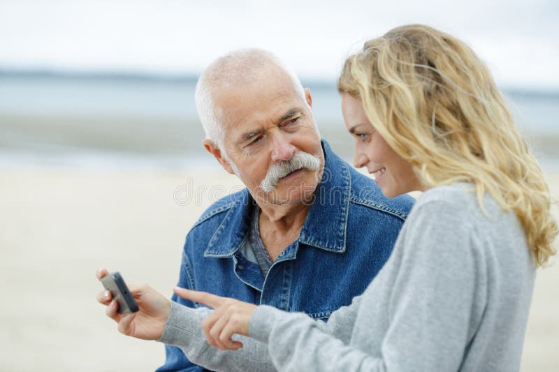 Father and Daughter Checking Phone Stock Photo - Image of middle ...