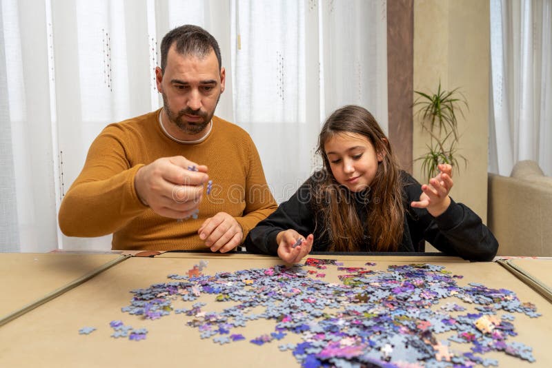 Father and Daughter Dejected by the Difficulty of Assembling a Puzzle ...