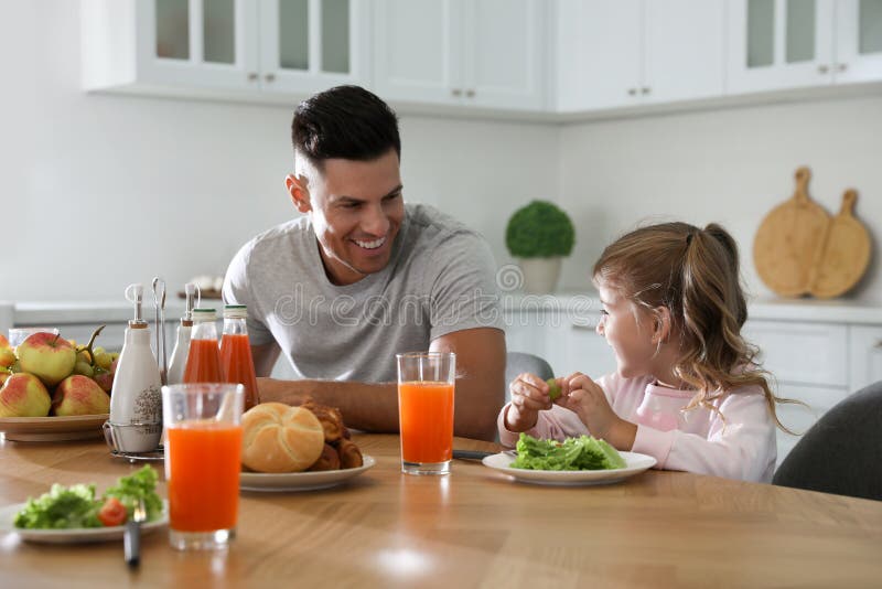 Father with Daughter Having Breakfast Together at Table in Modern ...