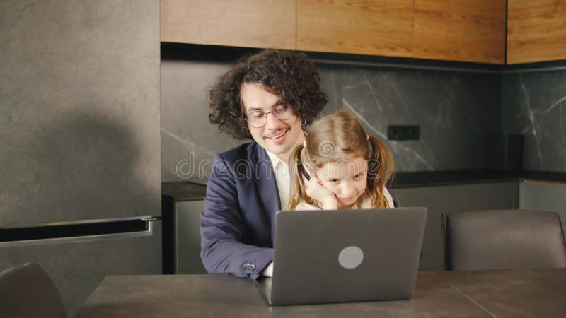 A Heartwarming Scene of a Father and Daughter Working on a Laptop ...