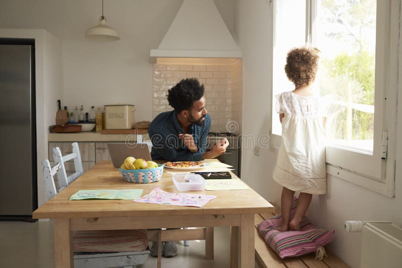 Father and Daughter Paint and Eat Pizza at Kitchen Table Stock Image ...