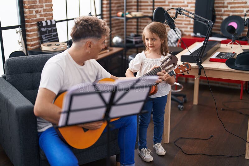 Father and Daughter Playing Classical Guitar and Ukulele at Music ...