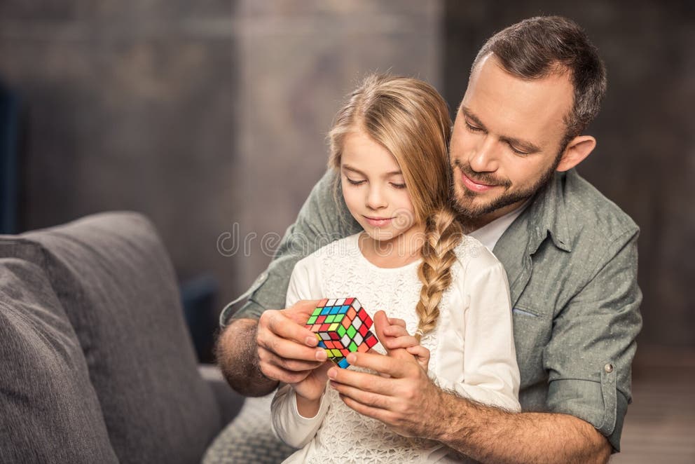 Father and Daughter Playing with Cube Editorial Stock Image - Image of ...