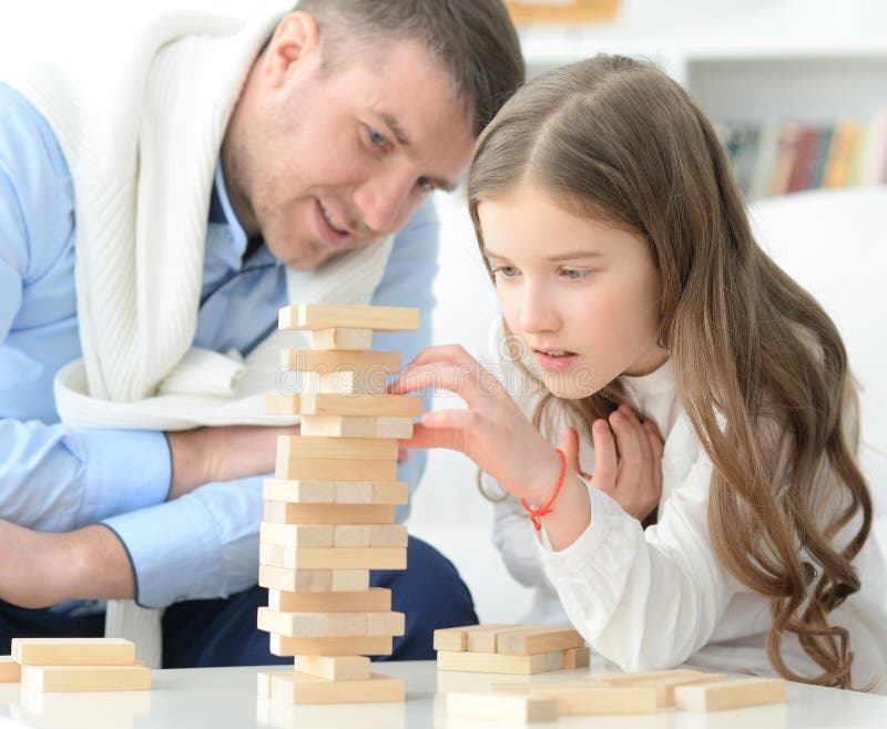 Father and Daughter Playing a Game Stock Photo - Image of game, table ...