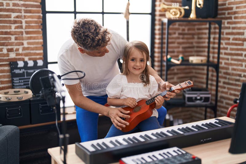 Father and Daughter Playing Ukulele at Music Studio Stock Photo - Image ...
