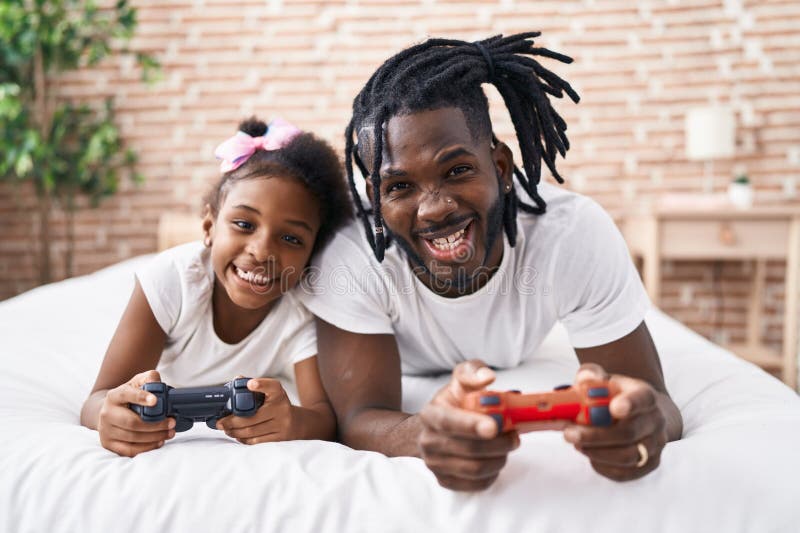 Father and Daughter Playing Video Game Lying on Bed at Bedroom Stock ...
