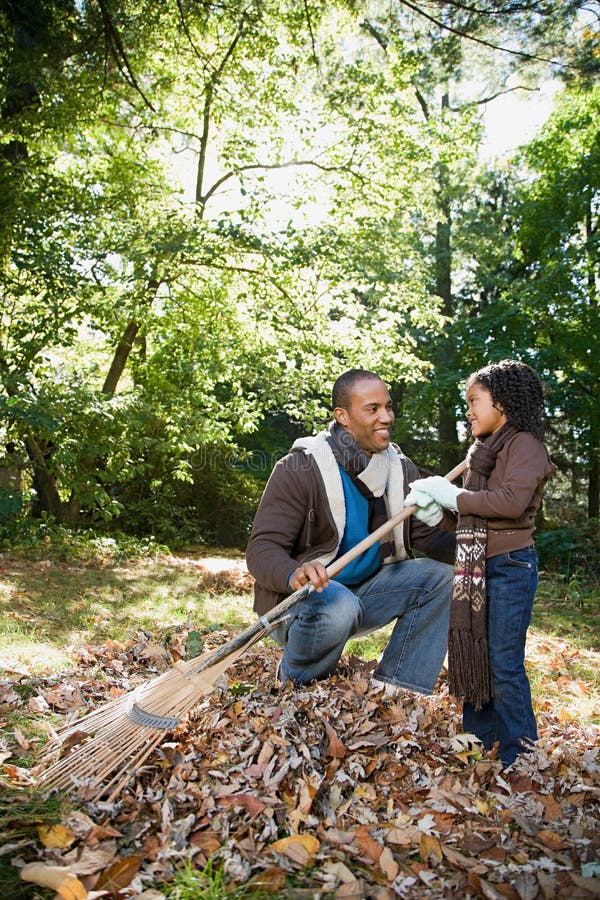 Father and Daughter Raking Leaves Stock Image - Image of leaf, family ...