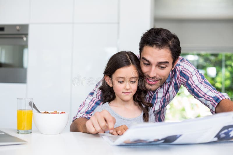 Father and Daughter Reading Newspaper at Home Stock Image - Image of ...
