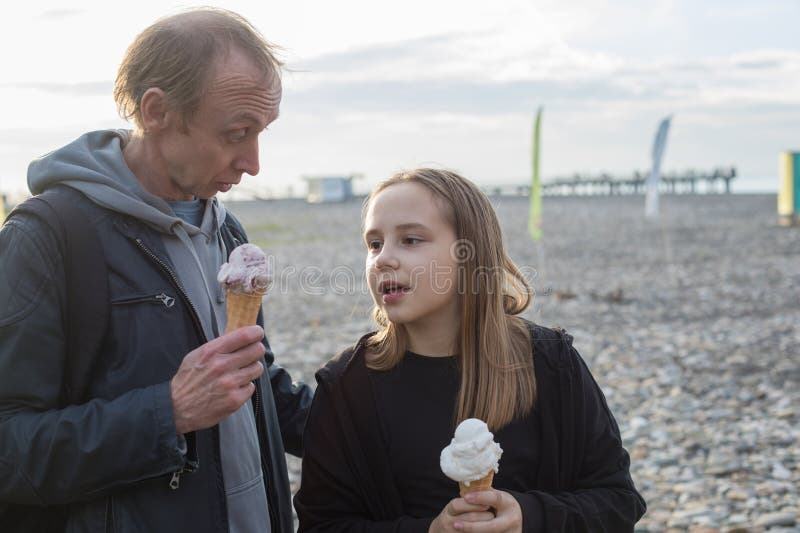 Father and Daughter Sharing Smiles and Ice Cream Cones Outdoors Stock ...