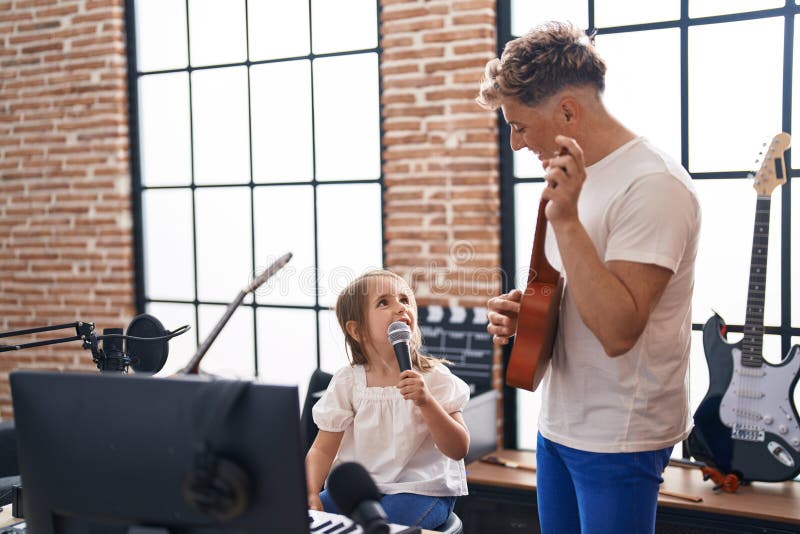 Father and Daughter Singing Song Playing Ukulele at Music Studio Stock ...