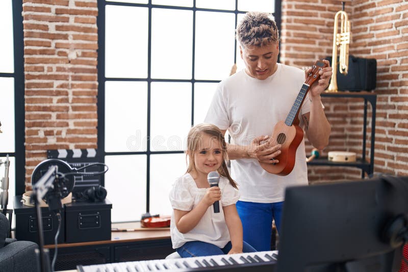Father and Daughter Singing Song Playing Ukulele at Music Studio Stock ...