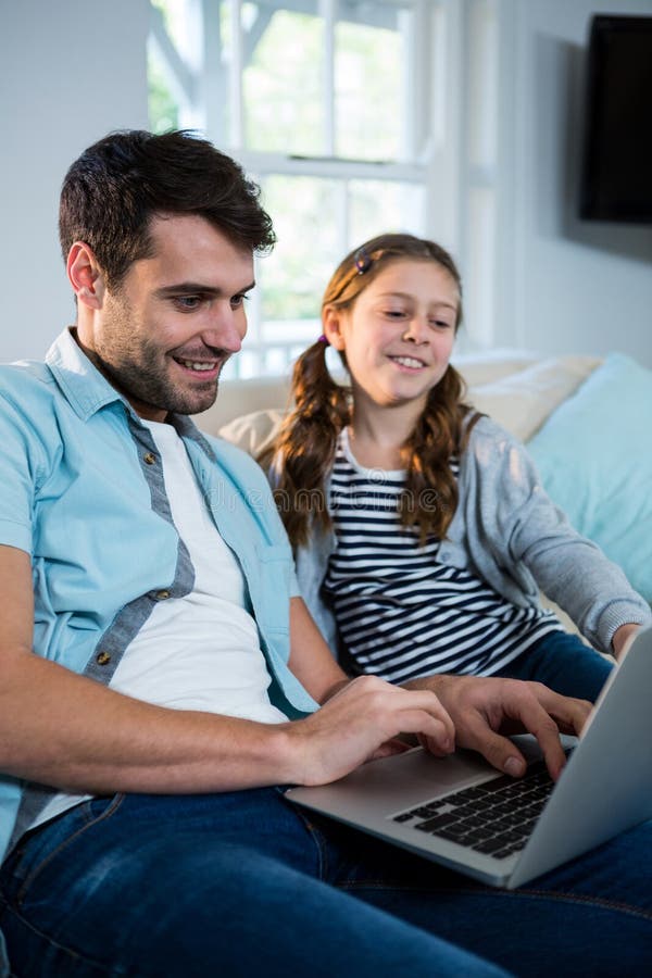 Father and Daughter Using Laptop in the Living Room Stock Image - Image ...