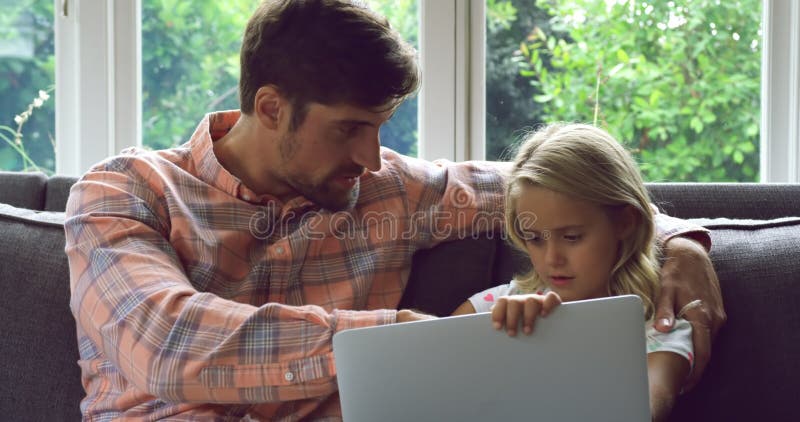 Father and Daughter Using Laptop on Sofa at Home 4k Stock Footage ...