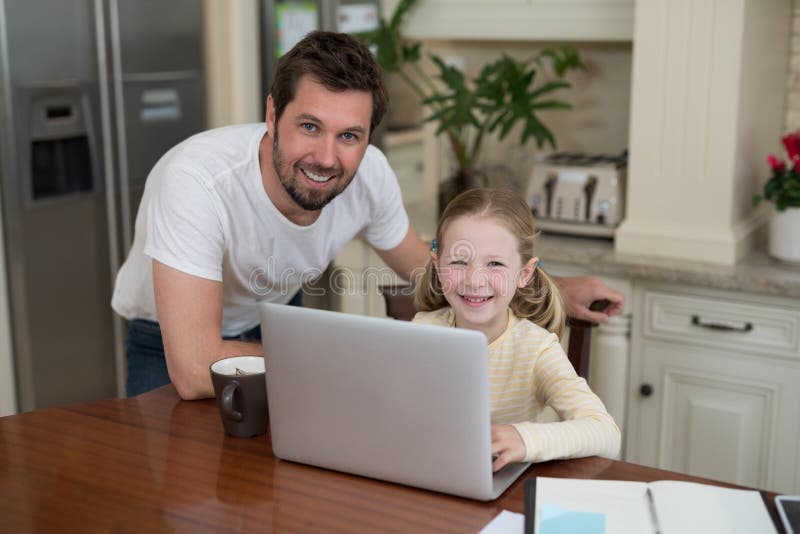 Father and Daughter Working on Laptop at Home Stock Image - Image of ...